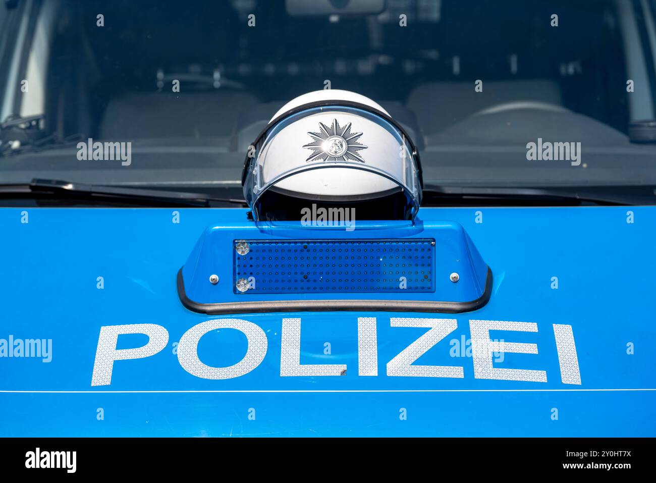 Police, patrol car, helmet lying on the hood, during a break, symbolic ...