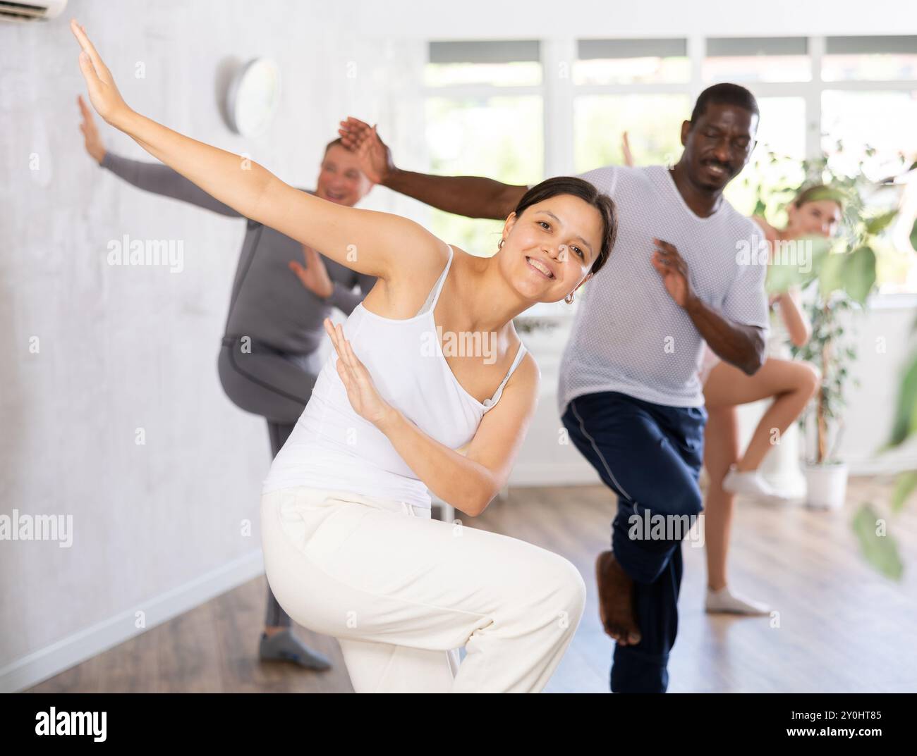 Active men and women of different ages practicing Hip-hop dance in ...