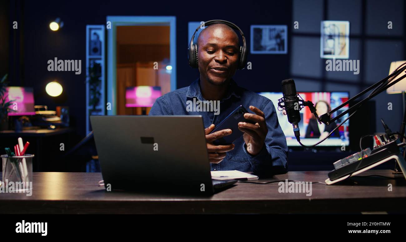 Portrait of BIPOC tech vlogger reviewing newly released smartphone in ...