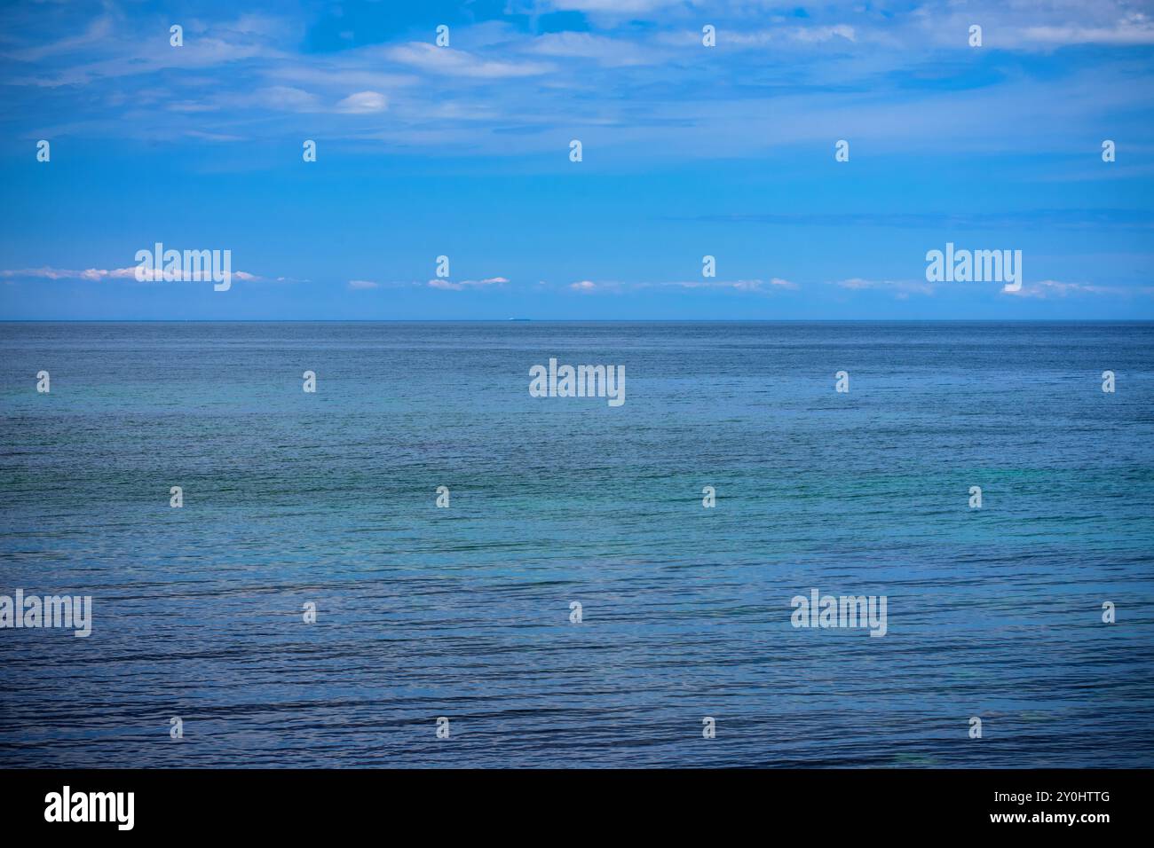 Blue-green large mass of Baltic Sea waters near Danish town of Gudhjem ...