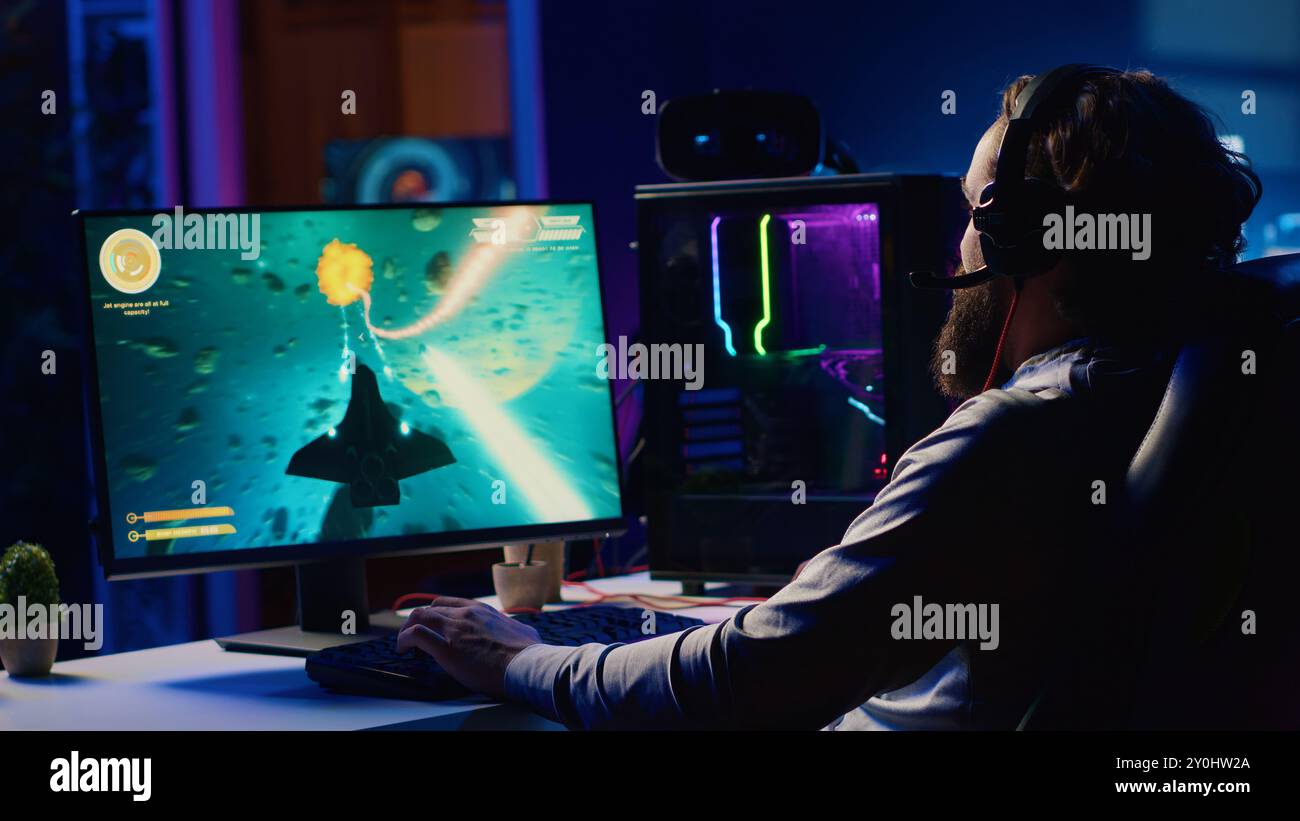 Man at home shooting asteroids in spaceship flying singleplayer game ...