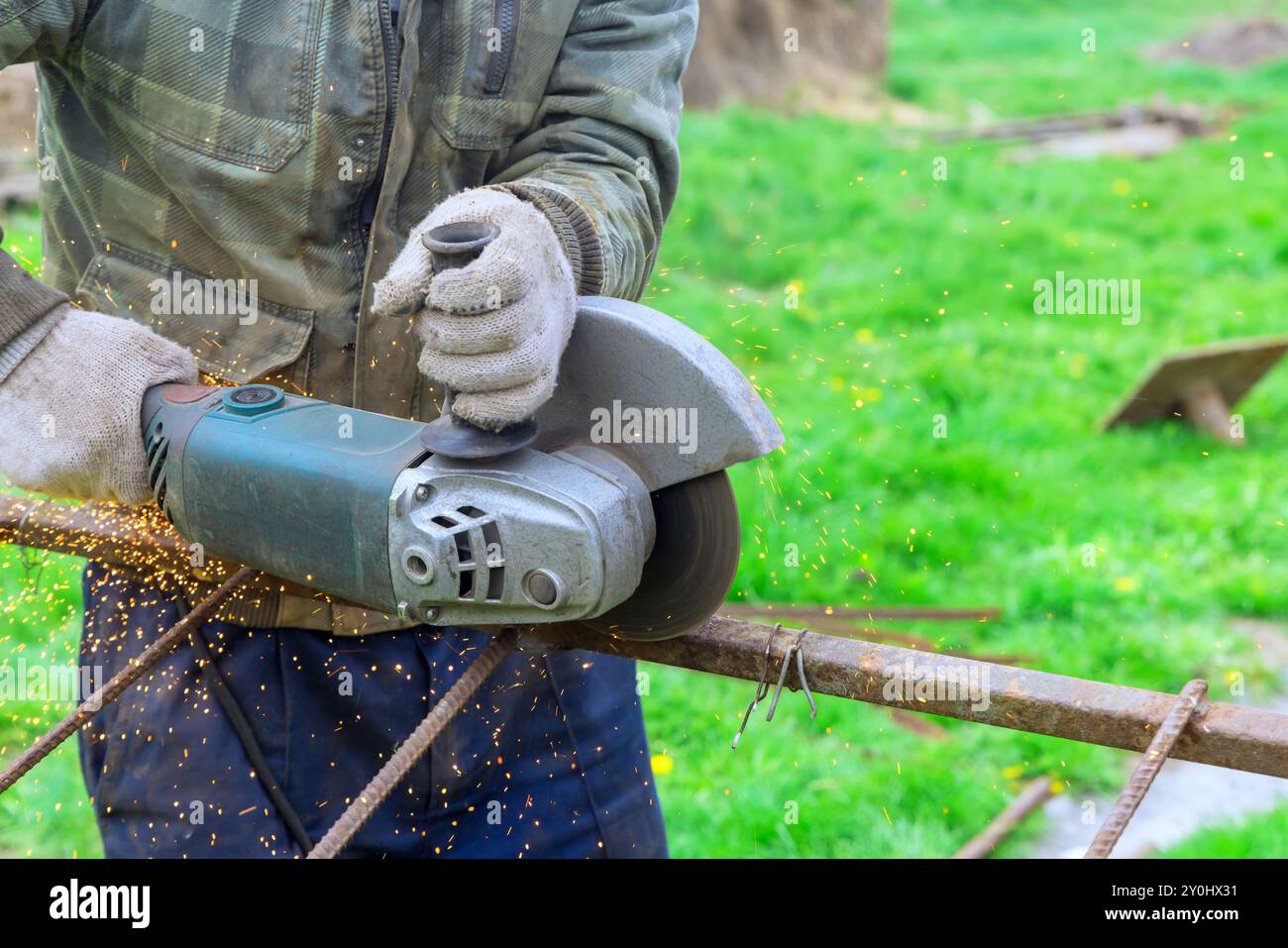 Worker cut metal frames with hand saw using angle grinder Stock Photo ...