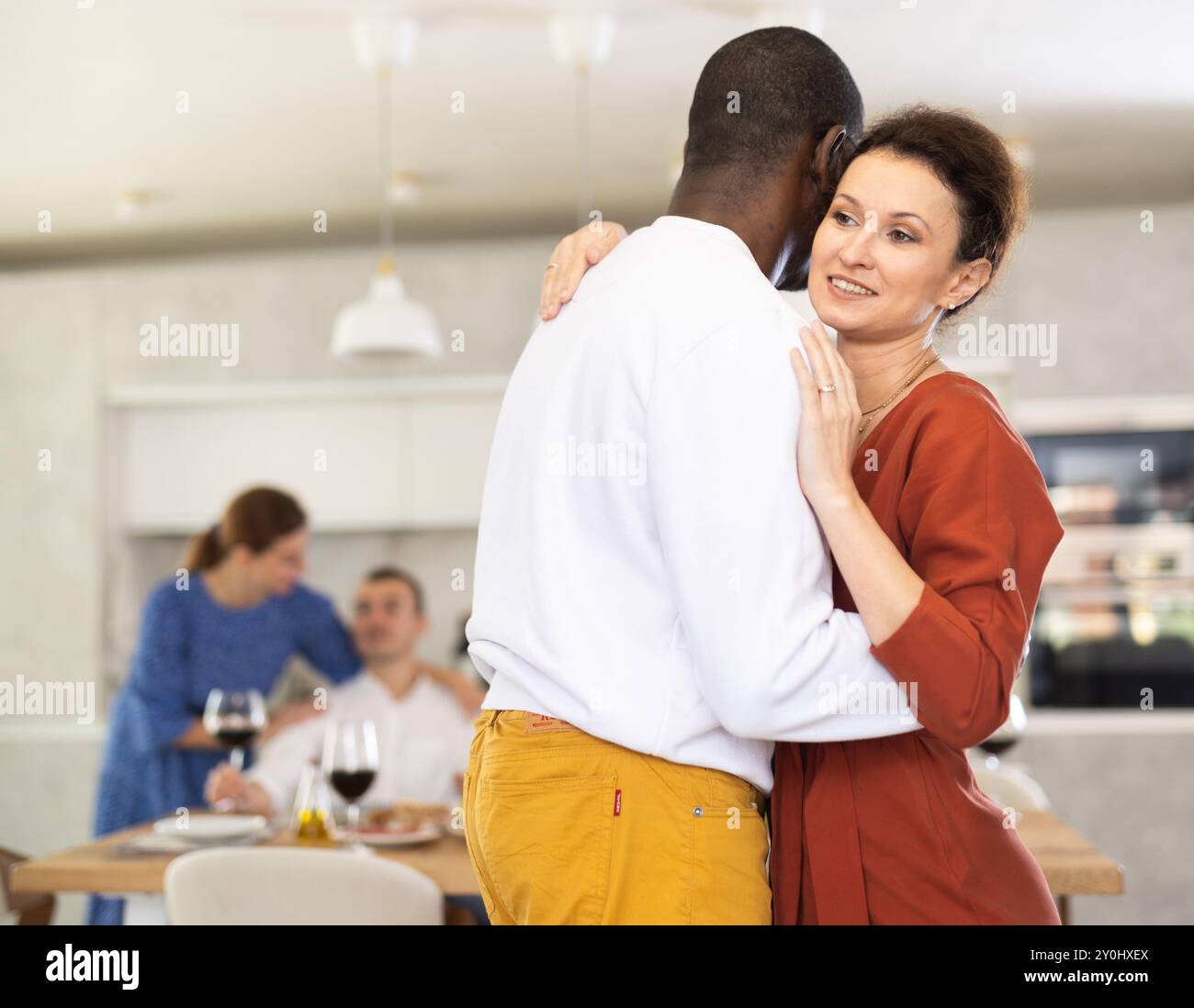 Friends party - men and women of different nationalities dancing slow ...