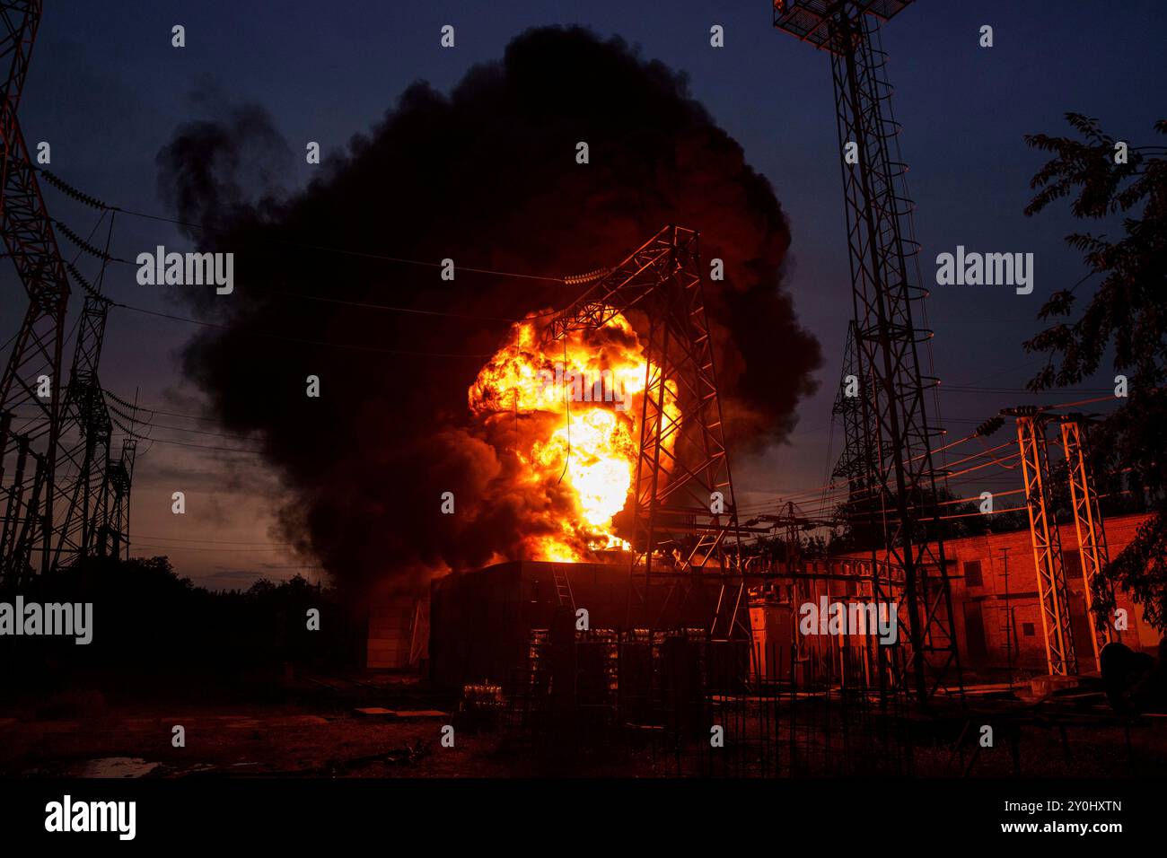 An electrical substation burns after a Russian bombing in ...