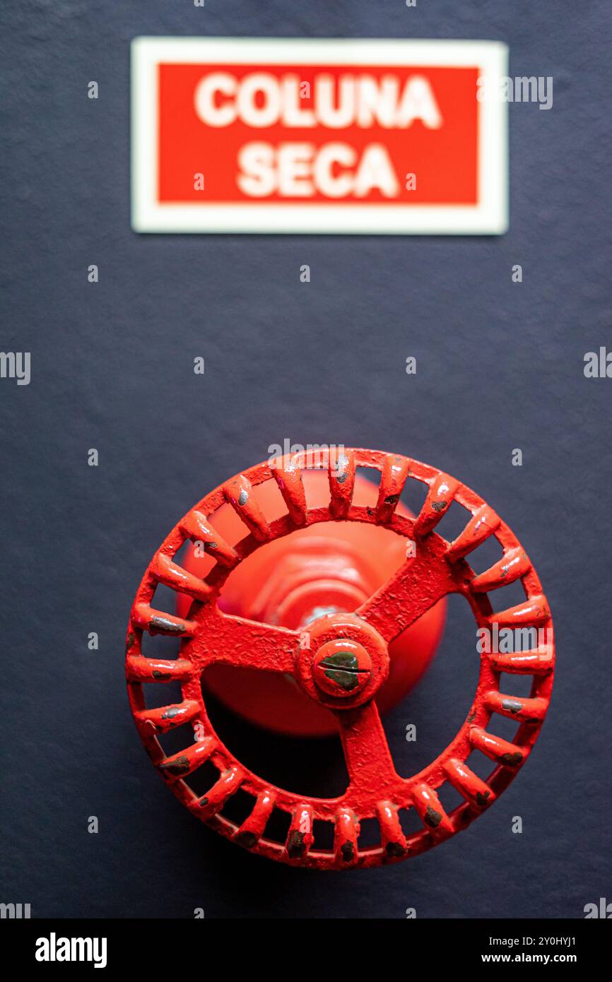 dry column, red tap on a black background in great contrast Stock Photo - Alamy