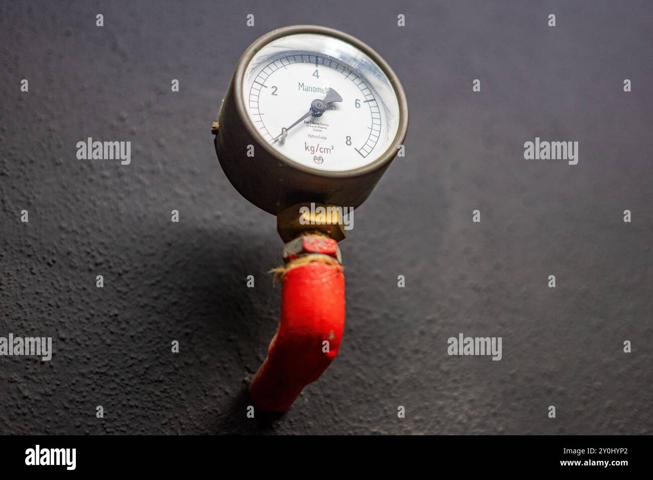 dry column water pressure gauge. red color on a black background in ...