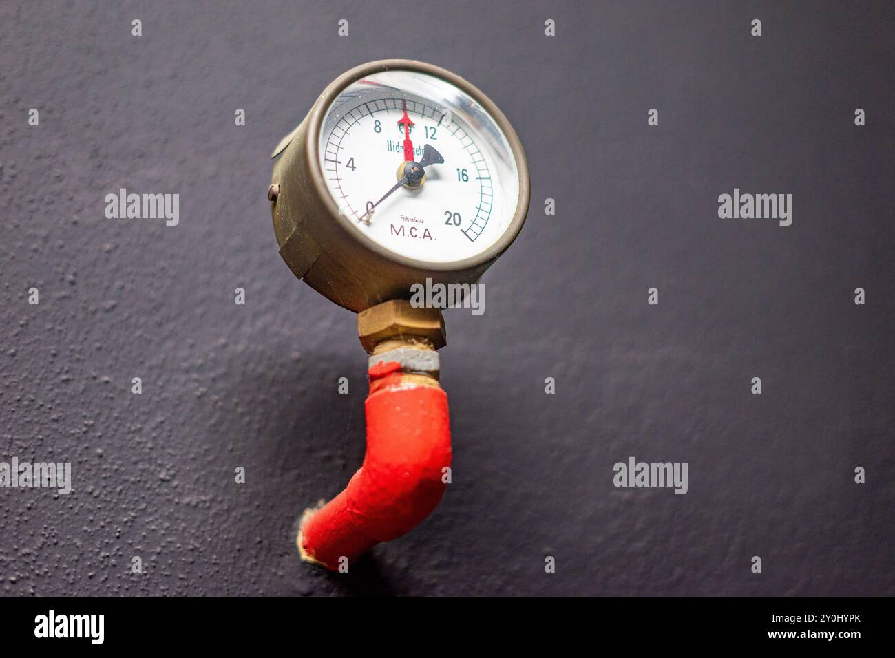 dry column water pressure gauge. red color on a black background in ...