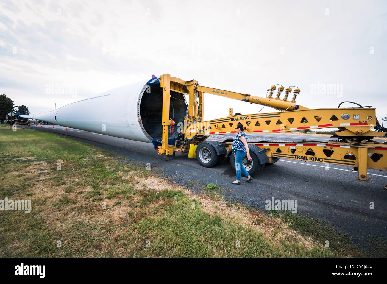 Specialized transport trucks carrying a giant windmill blade at an ...