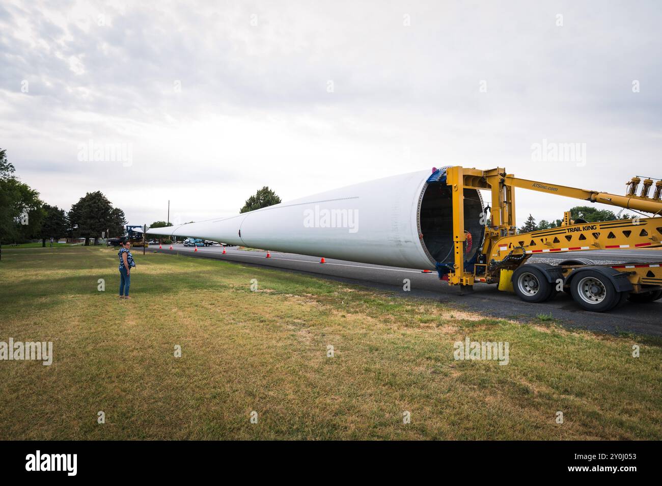 Specialized transport trucks carrying a giant windmill blade at an ...