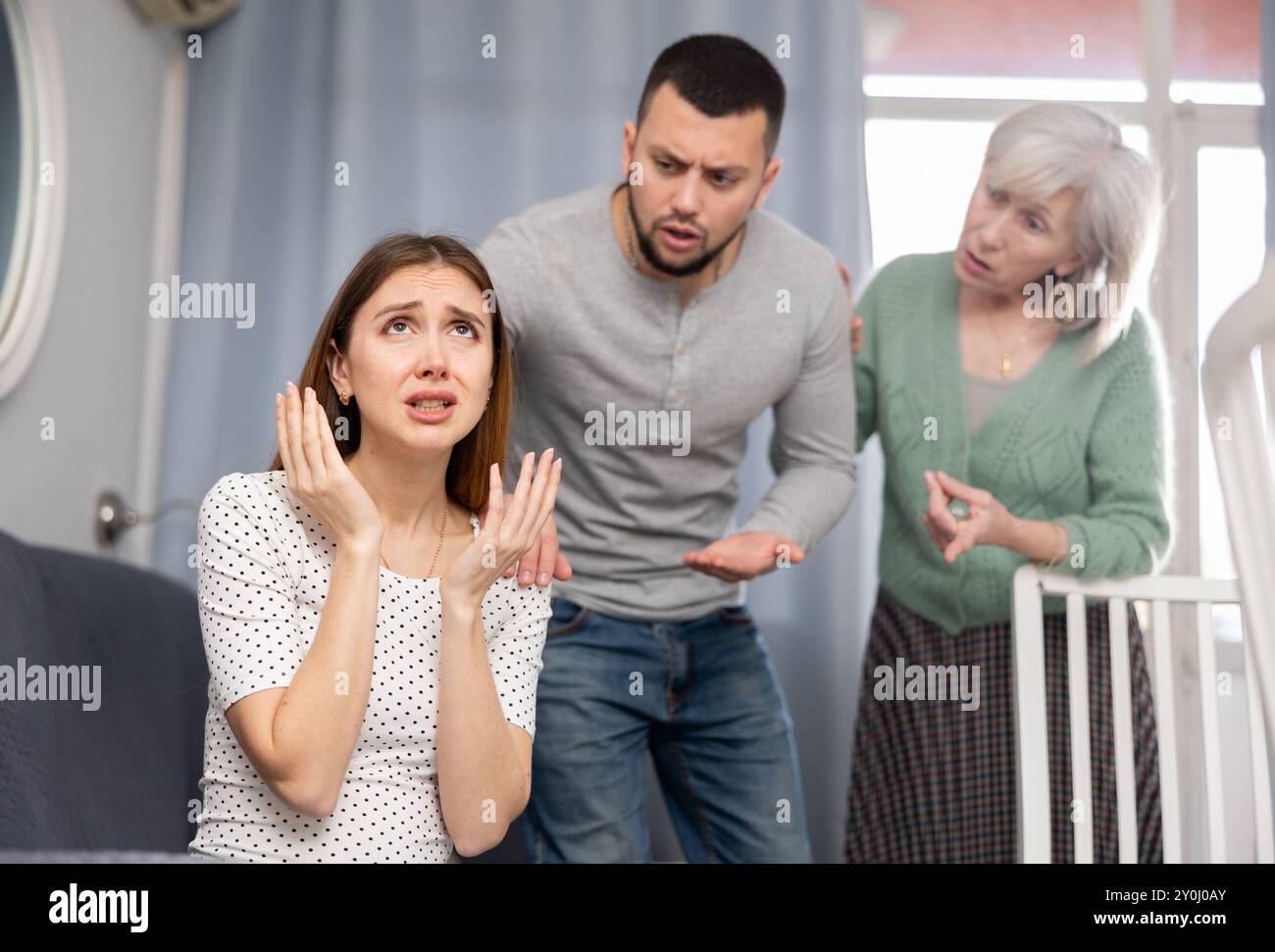 Domestic quarrel - husband and mother try to calm crying wife Stock ...