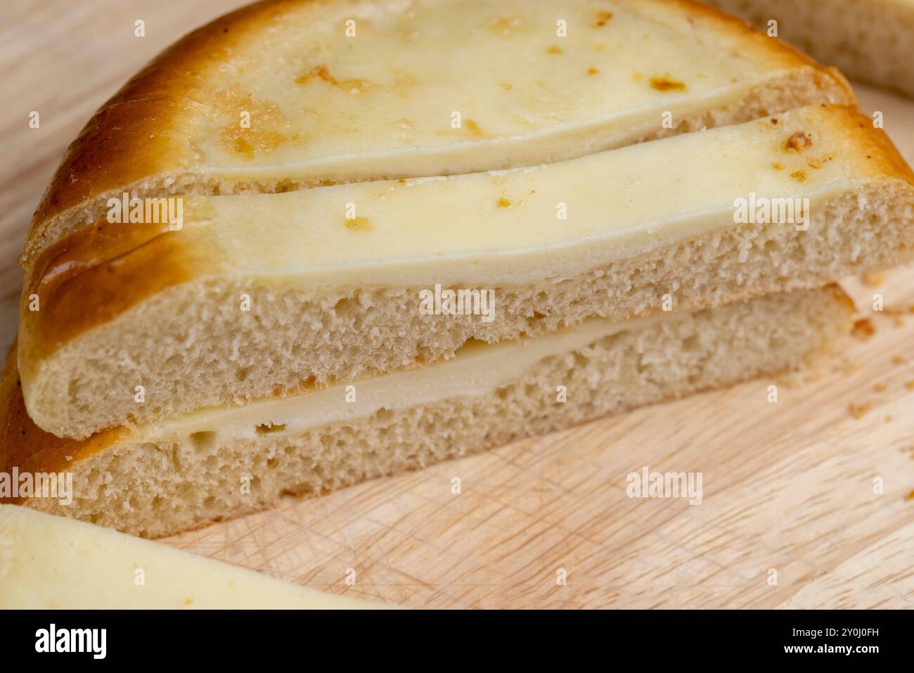 Cut into pieces round bun with creamy sour cream filling, sour cream ...