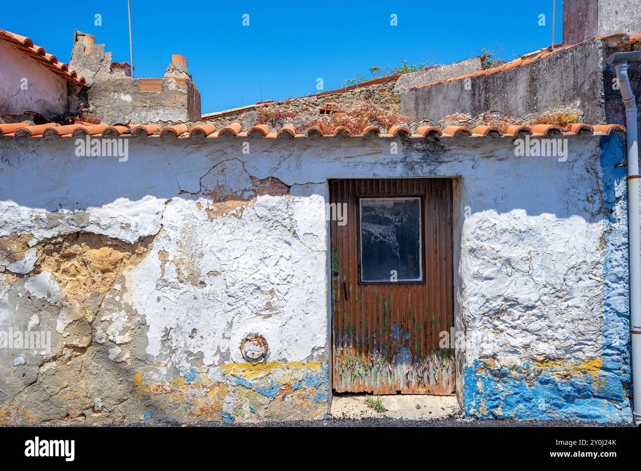Front facade of a small house in poor condition, typical of the ...