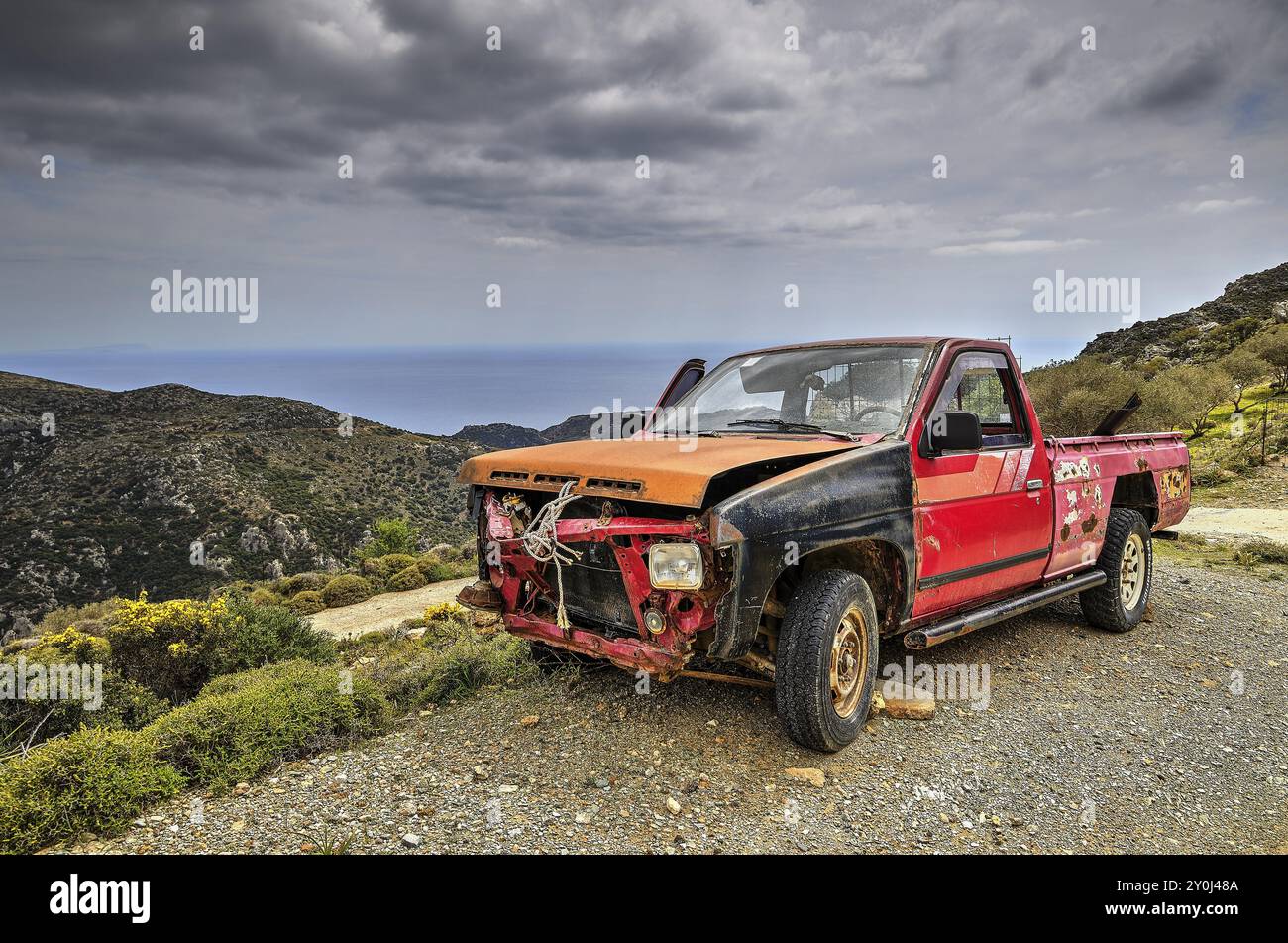 Degraded pickup truck in hilly landscape under cloudy sky, wrecked ...