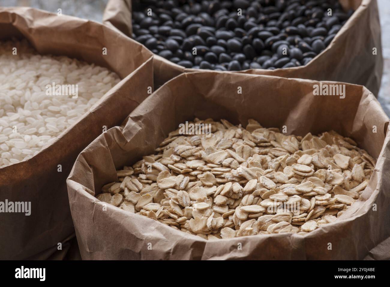 A close up of three different types of grains, Oats, rice, and black ...