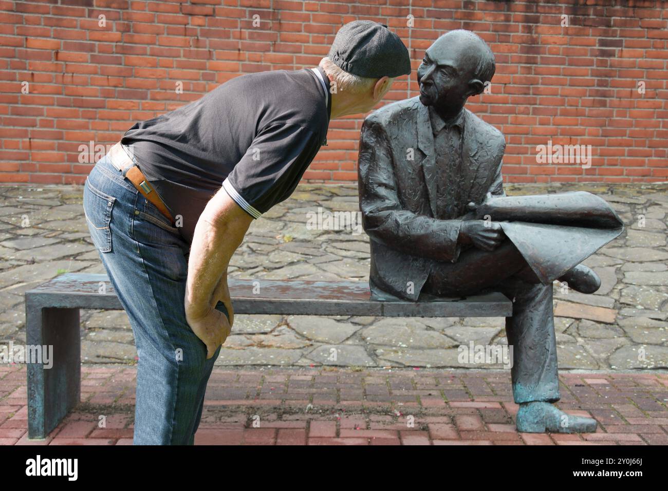 Funny, man looking at a bronze sculpture sitting on a bench Stock Photo ...