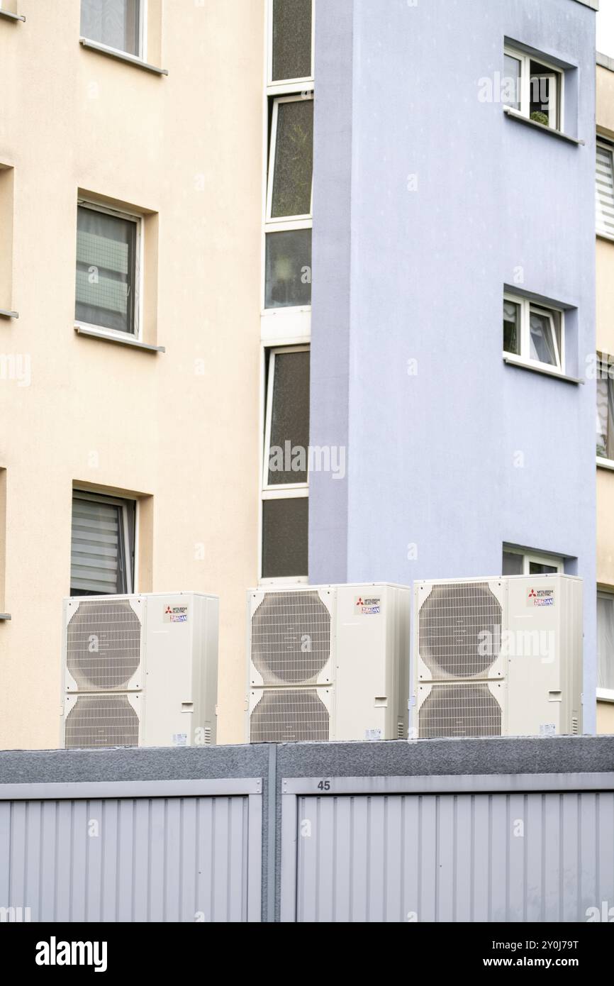 Heat pumps in a residential area, multi-family houses are supplied with ...