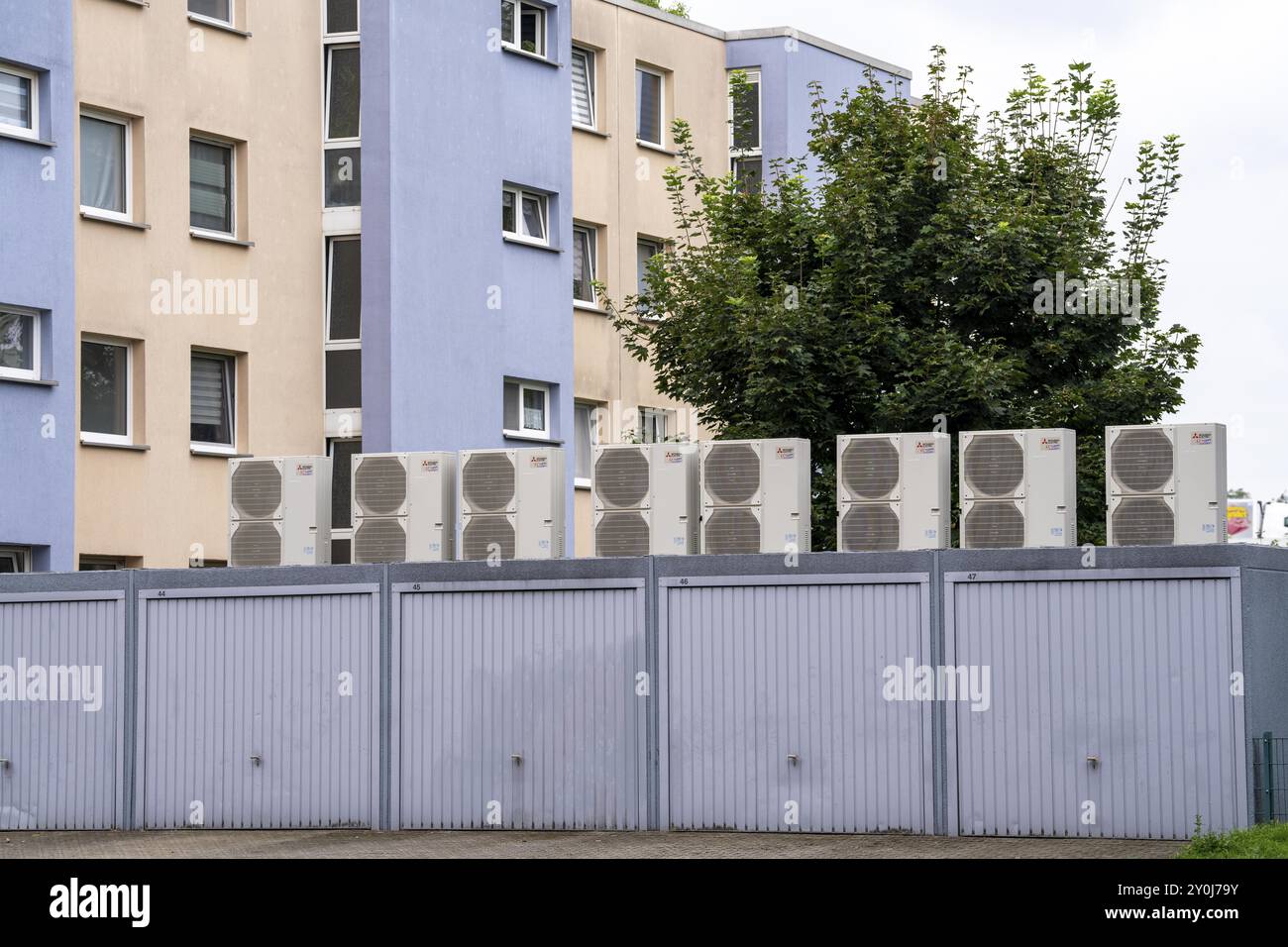 Heat pumps in a residential area, multi-family houses are supplied with ...