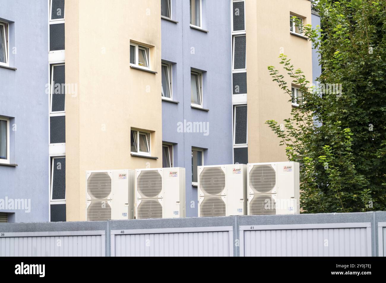 Heat pumps in a residential area, multi-family houses are supplied with ...