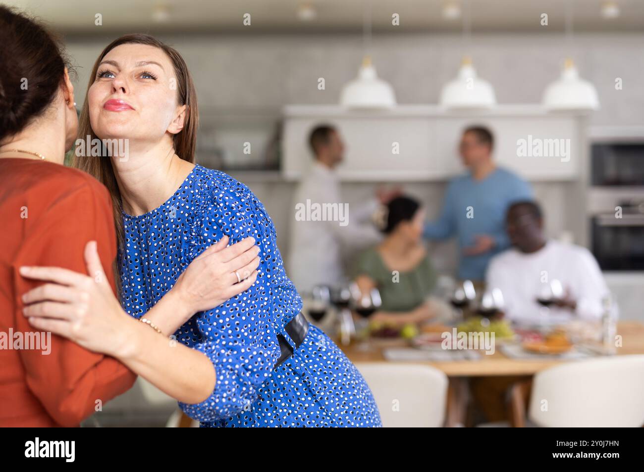 Two women greet each other when meeting Stock Photo - Alamy