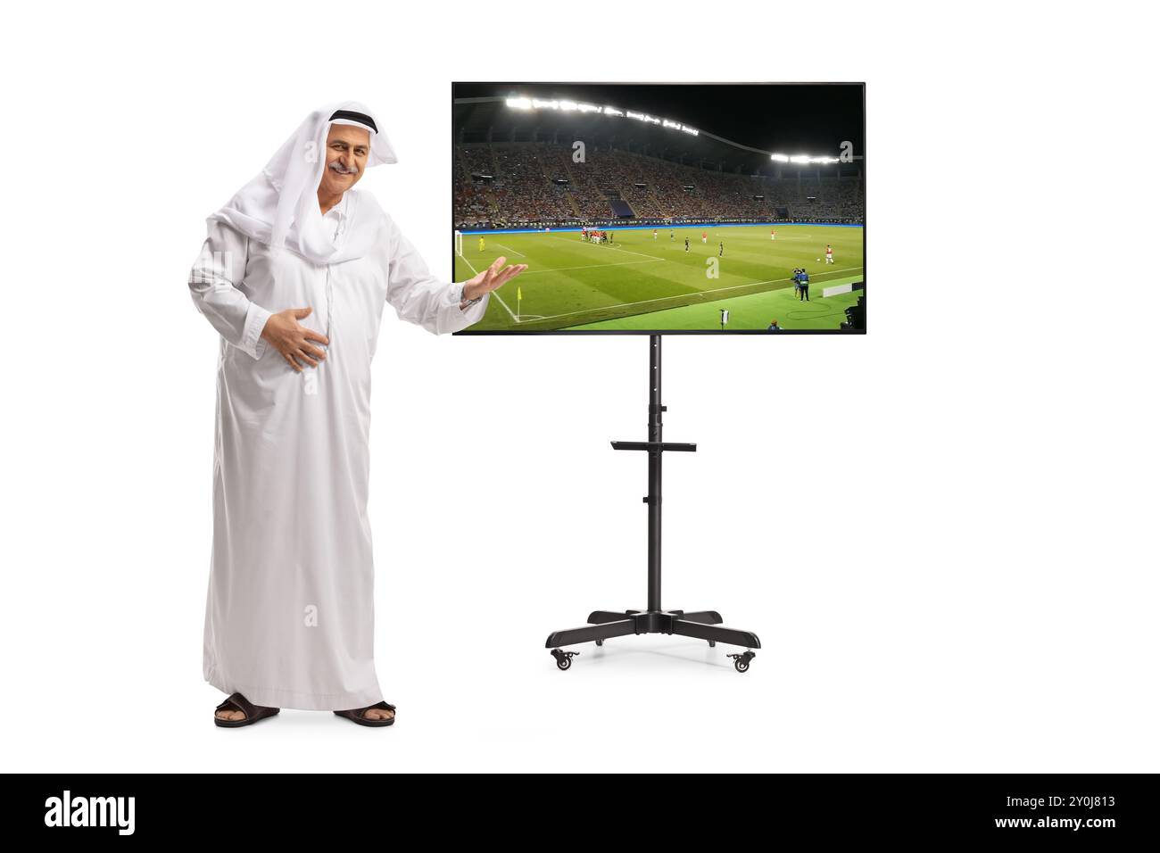 Full length portrait of a mature arab man in front of a tv showing ...