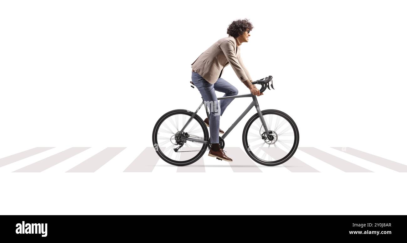 Full length profile shot of a young man in suit riding a bicycle at a ...