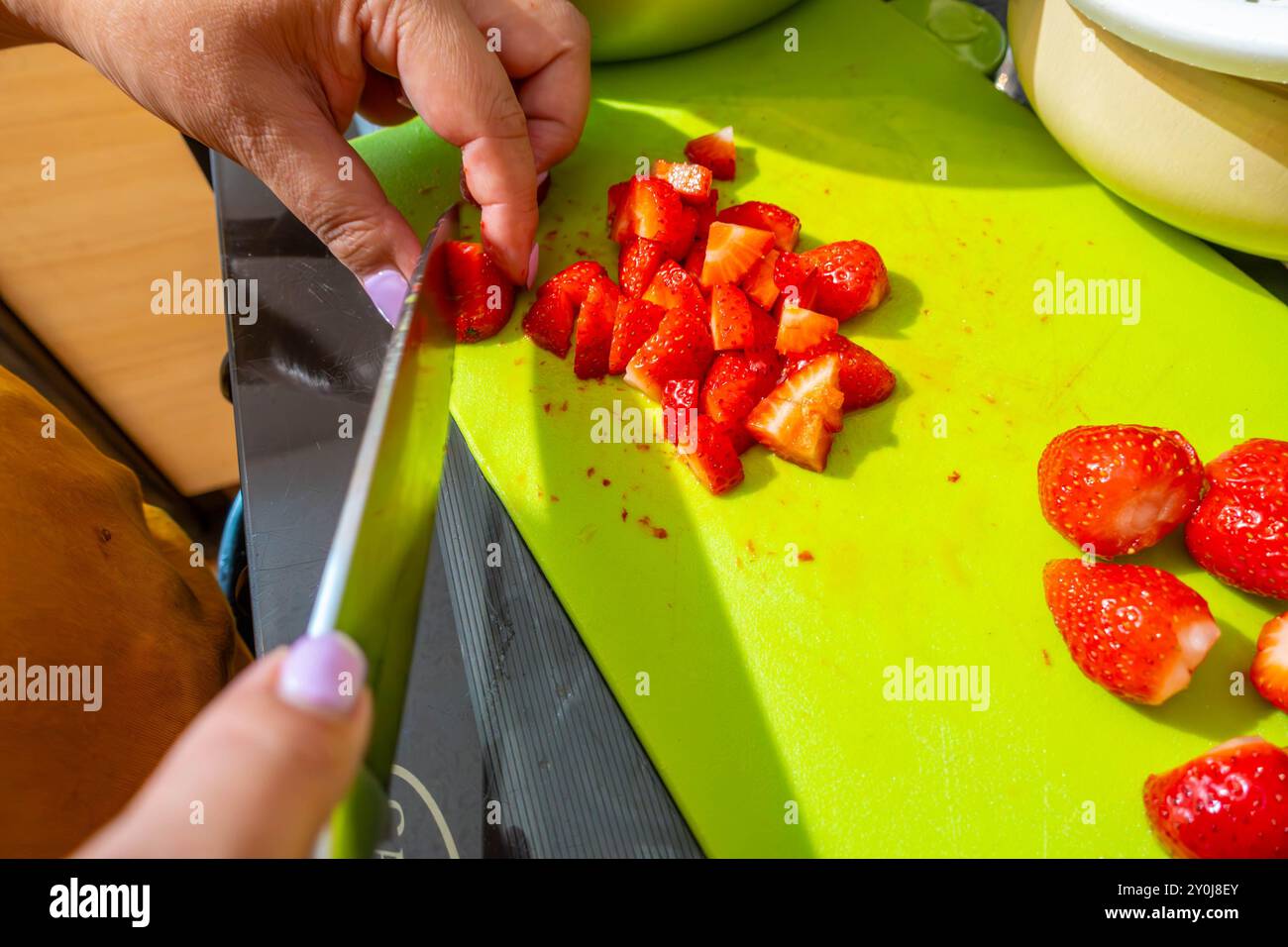 Female hands cut strawberries knife hi-res stock photography and images ...