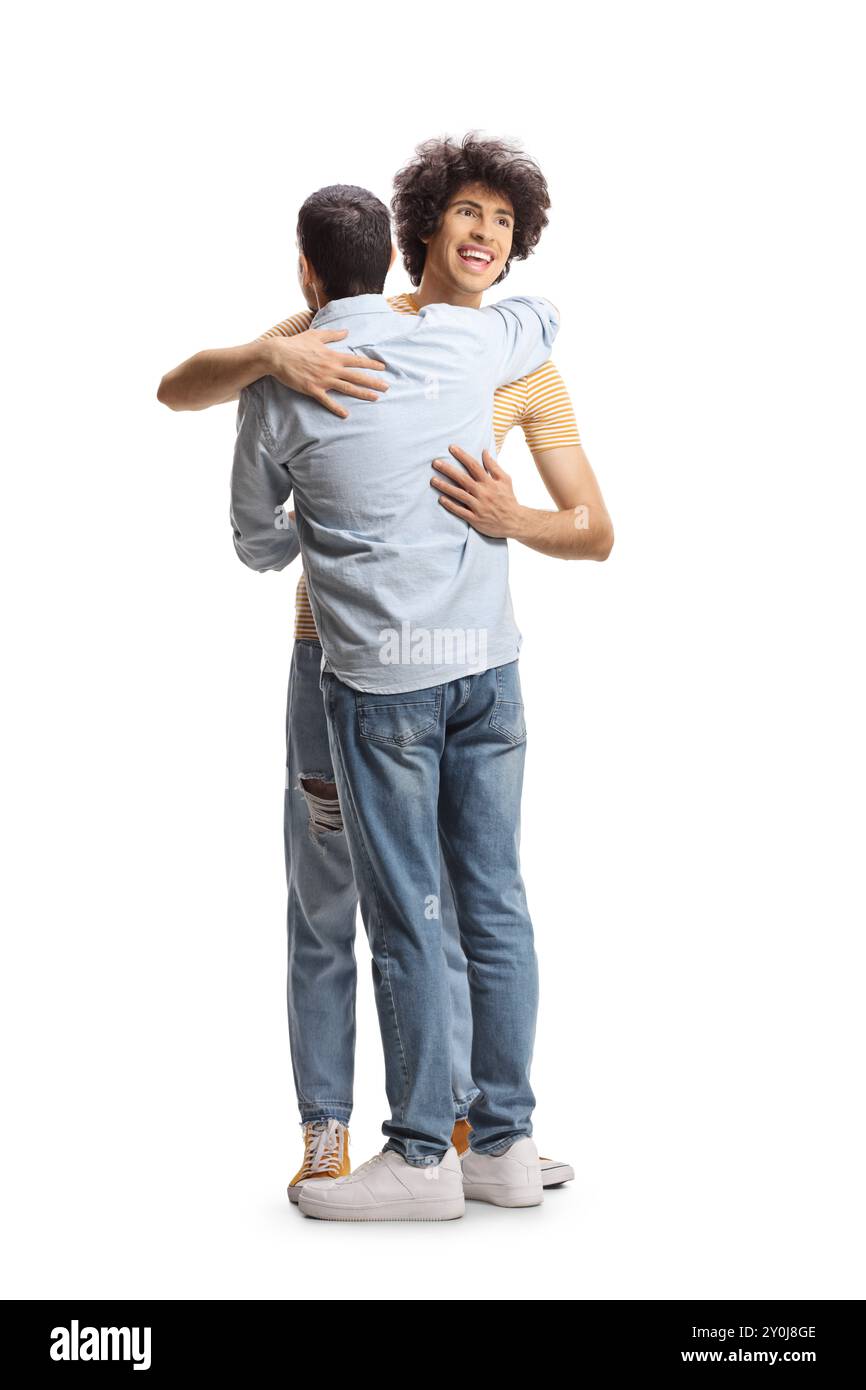 Full length shot of two young men hugging each other isolated on white ...