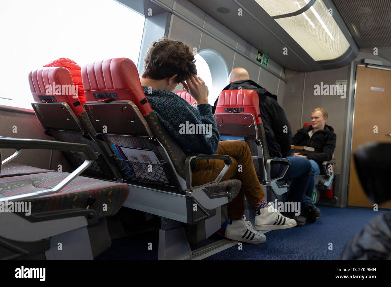 Passengers relax while riding the Victoria Clipper V ferry to Victoria ...