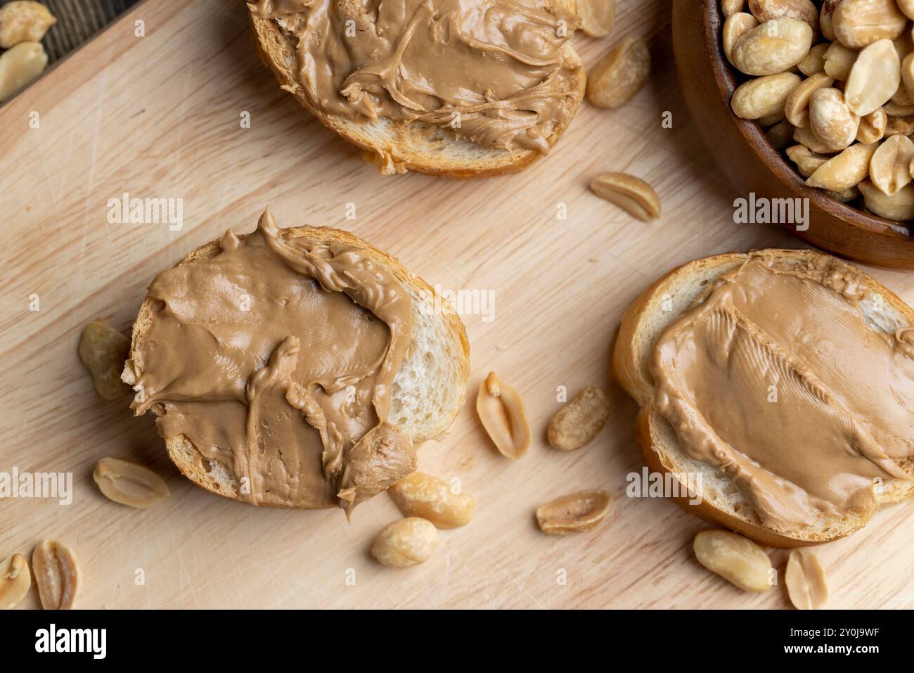 Peanut paste on a soft wheat baguette, made from peanut paste while making sandwiches Stock ...