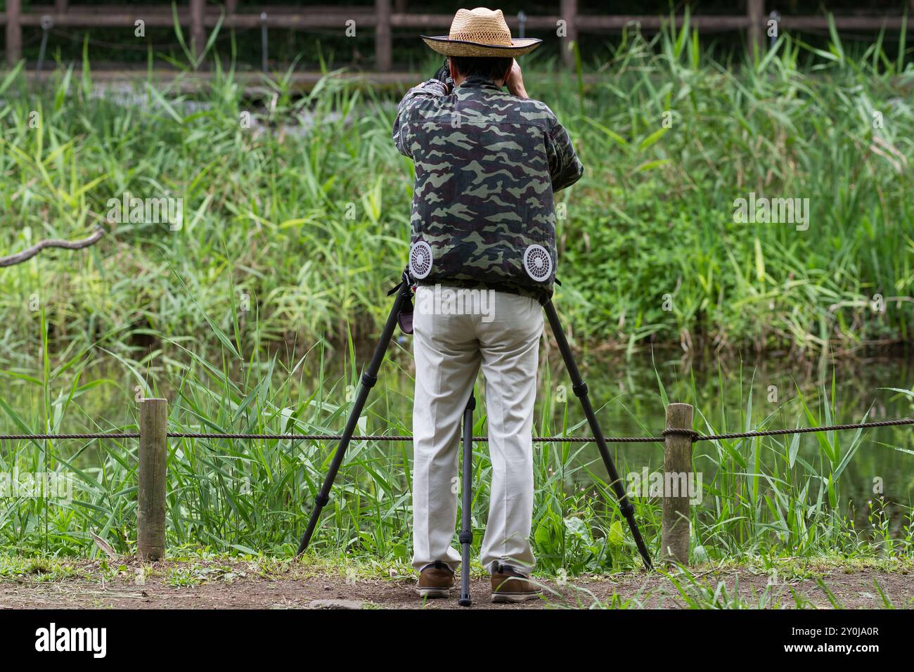 A photographer wearing a camouflaged Kuchofuku air-conditioned jackets ...