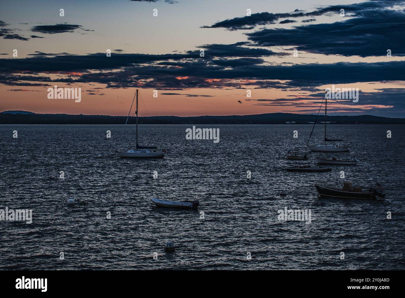 As the first light kisses the horizon, Maine’s coastline and boats come ...