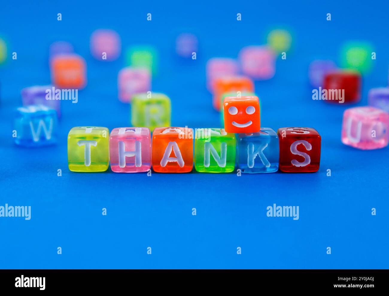 Colorful blocks that form the word thanks next to happy face Stock ...