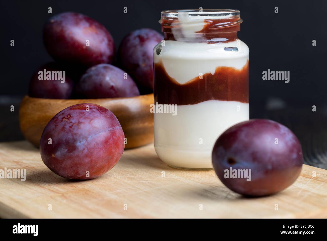 Fruit yogurt made from milk with plum flavor, a glass jar with yogurt ...