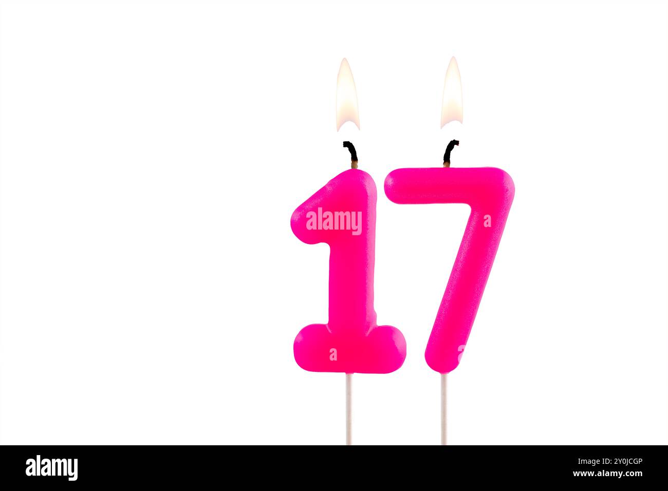 Pink number 17 birthday candle on white background Stock Photo - Alamy