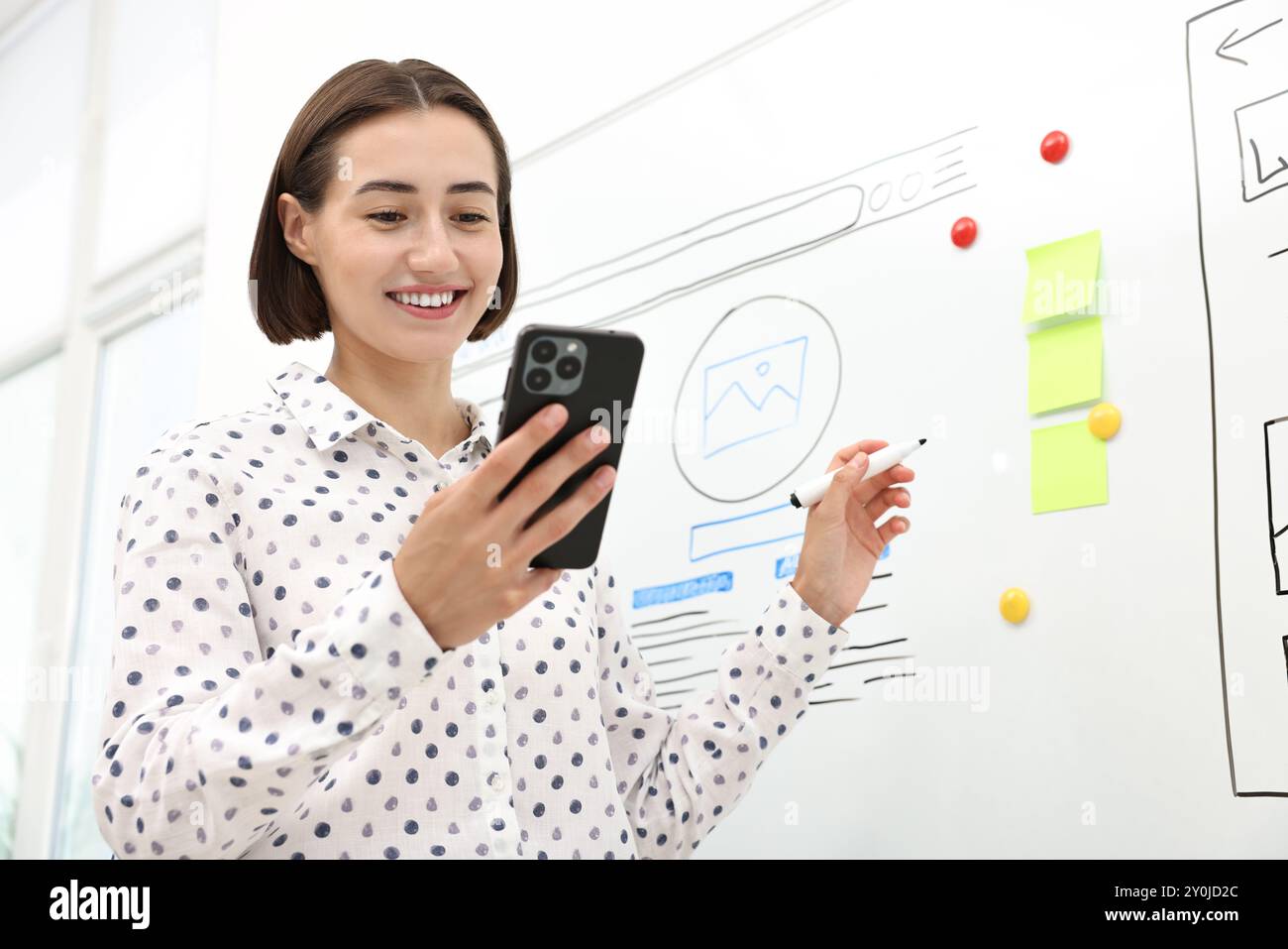 Developing UI design. Woman drawing website wireframe on whiteboard ...