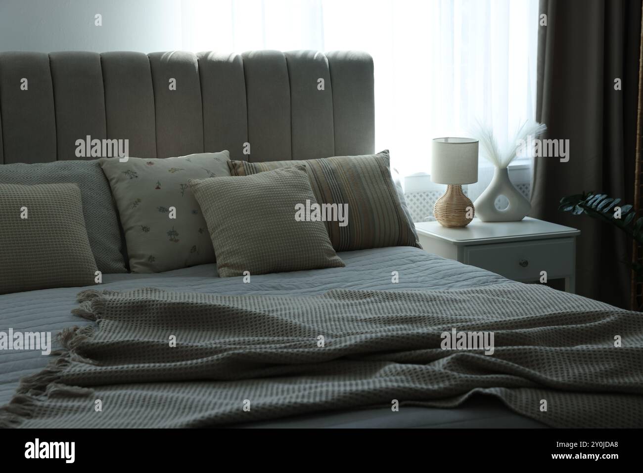 Big comfortable bed in room. Interior design Stock Photo - Alamy