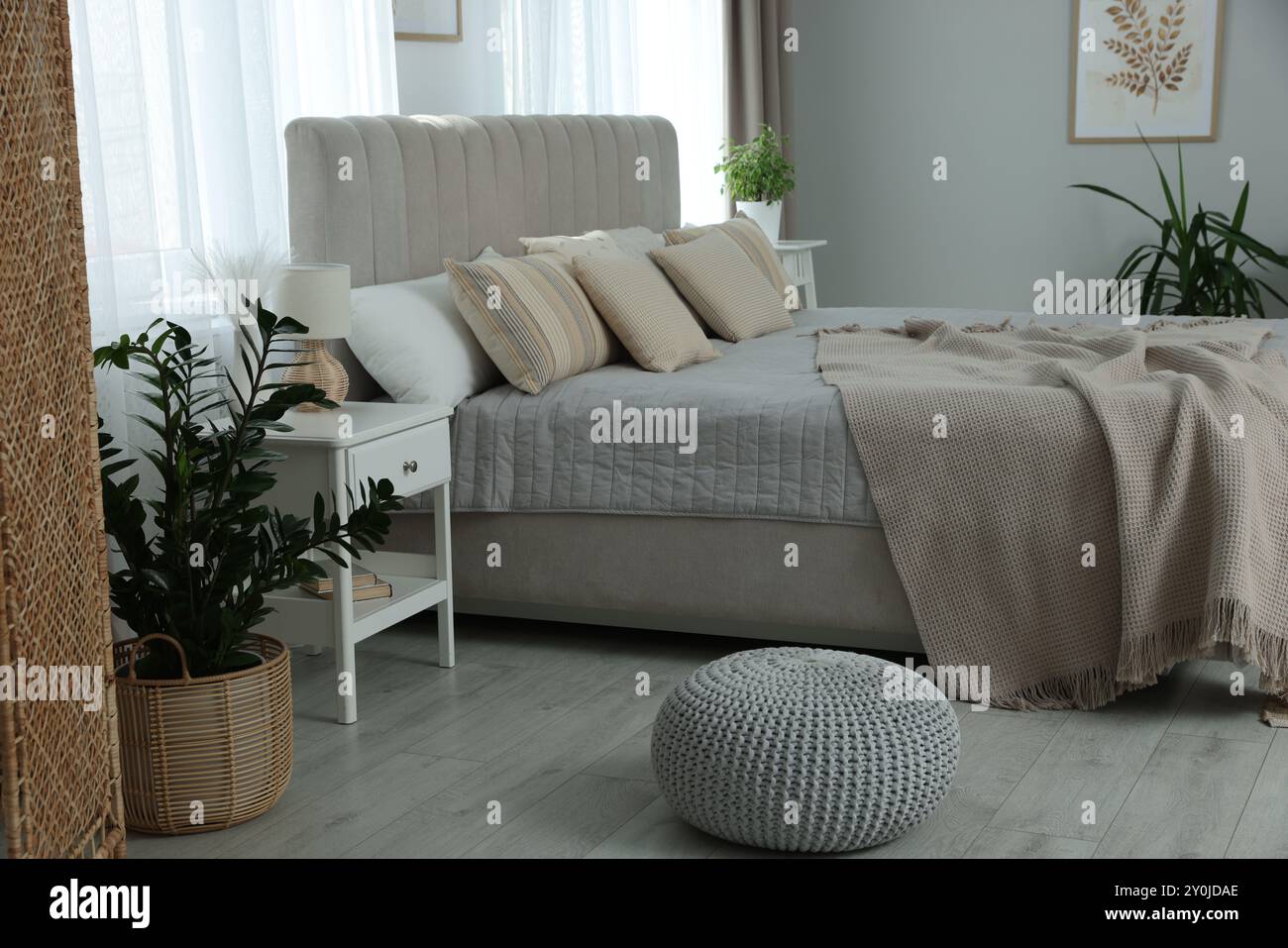 Big comfortable bed in room. Interior design Stock Photo - Alamy