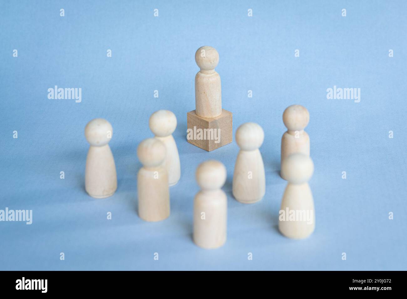 People toy blocks with one standing on a podium. Illustrate leadership ...