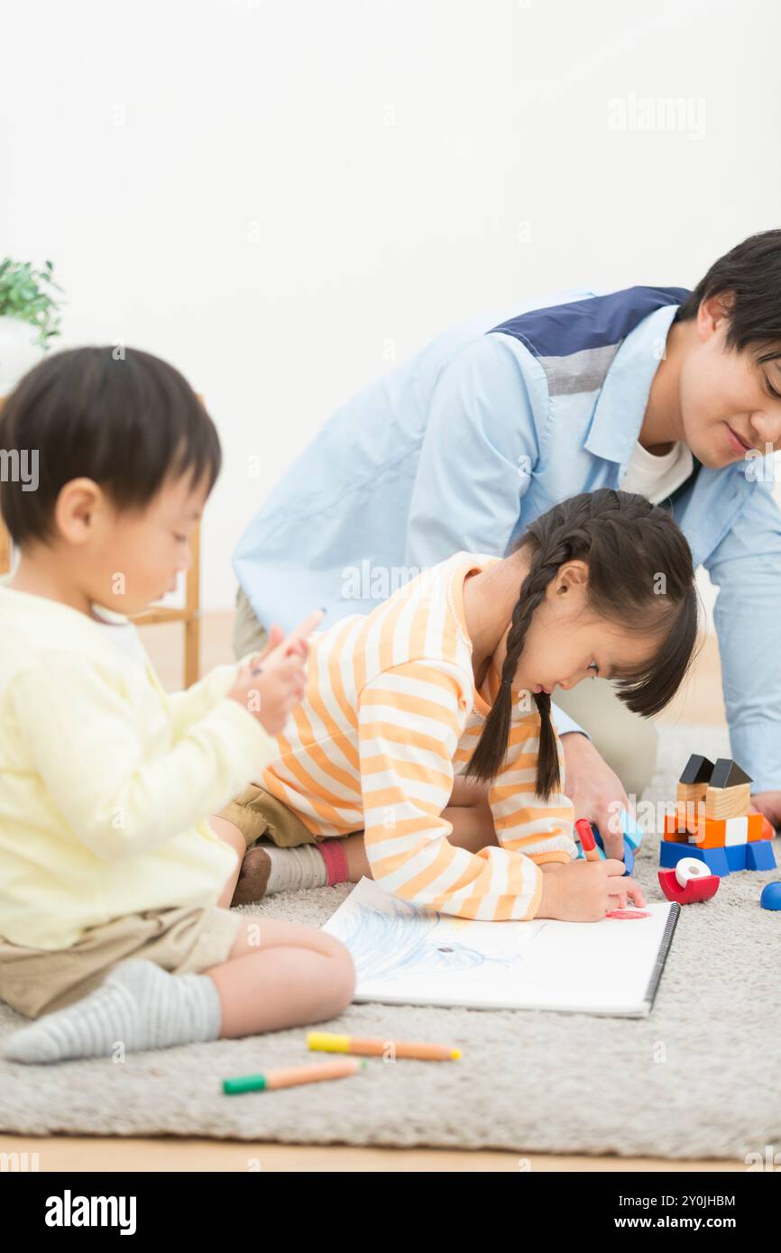 A father and his siblings playing in the living room Stock Photo - Alamy