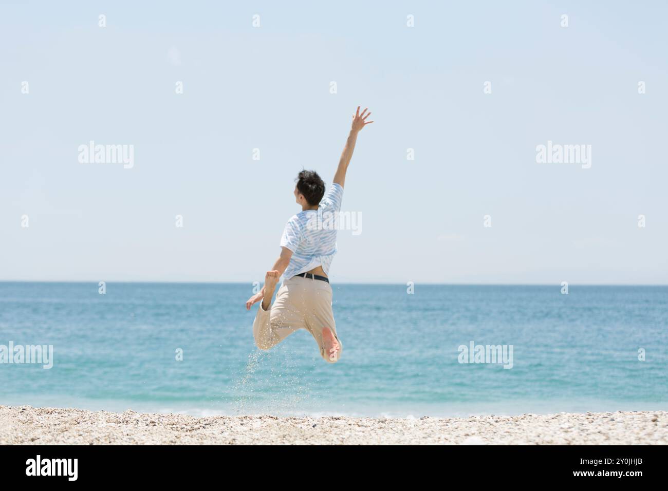 Man jumping on the beach Stock Photo - Alamy