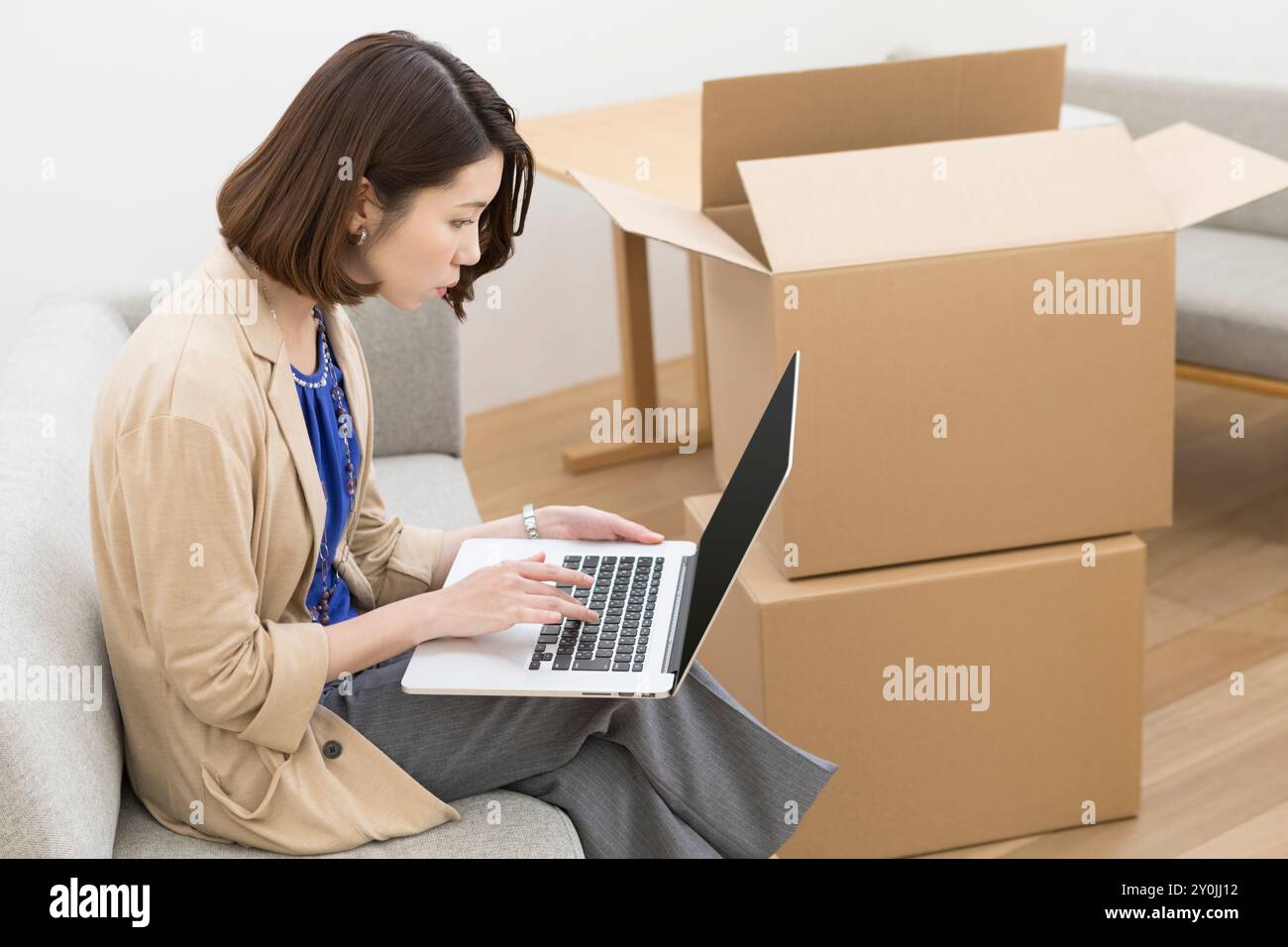 Woman looking at computer Stock Photo - Alamy