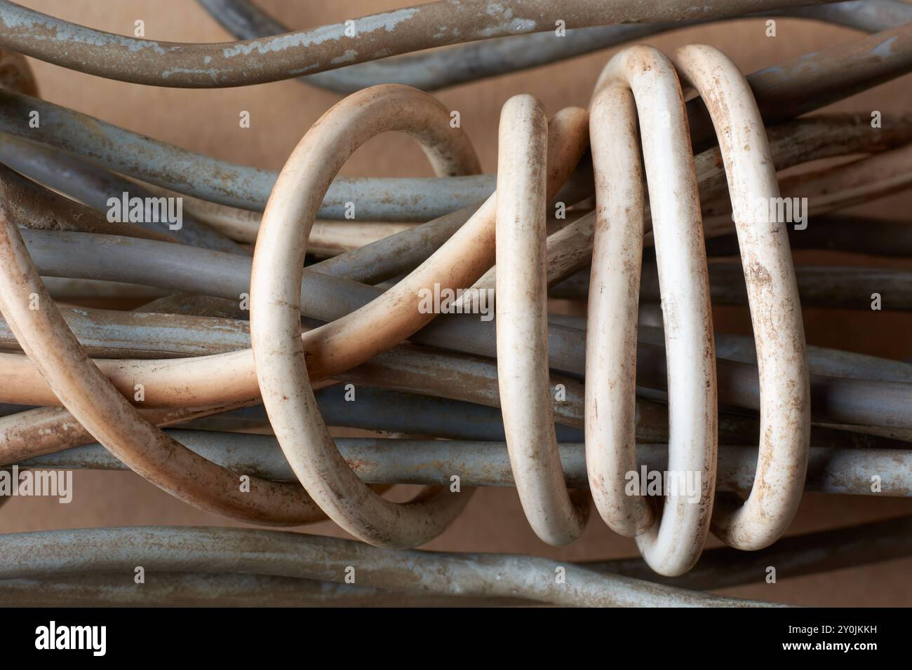 old use electric wires or cables close-up, pile of discarded white and ...