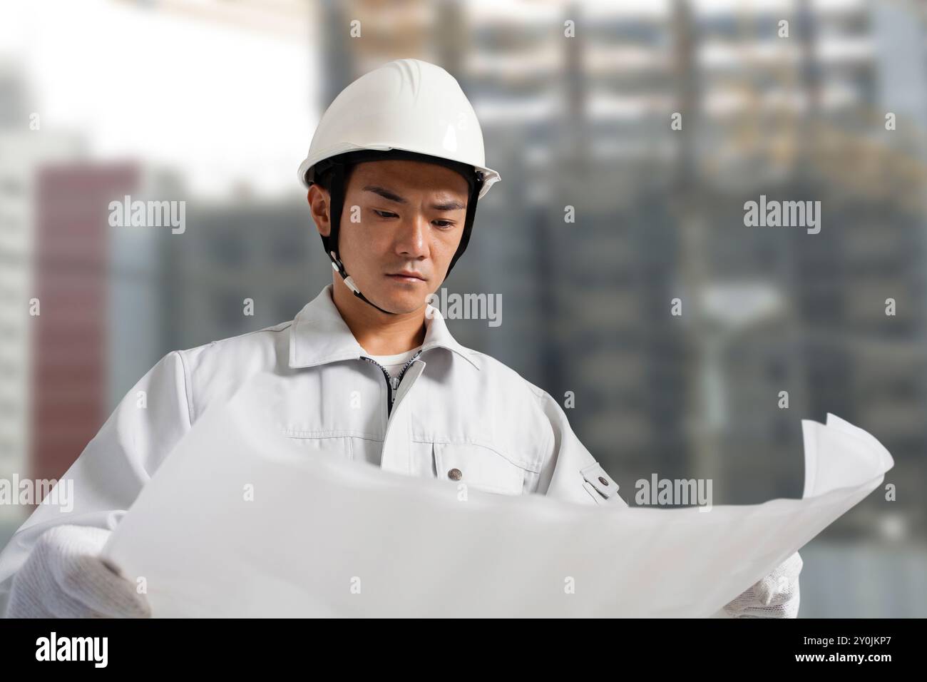 Male workers spreading out a diagram Stock Photo - Alamy