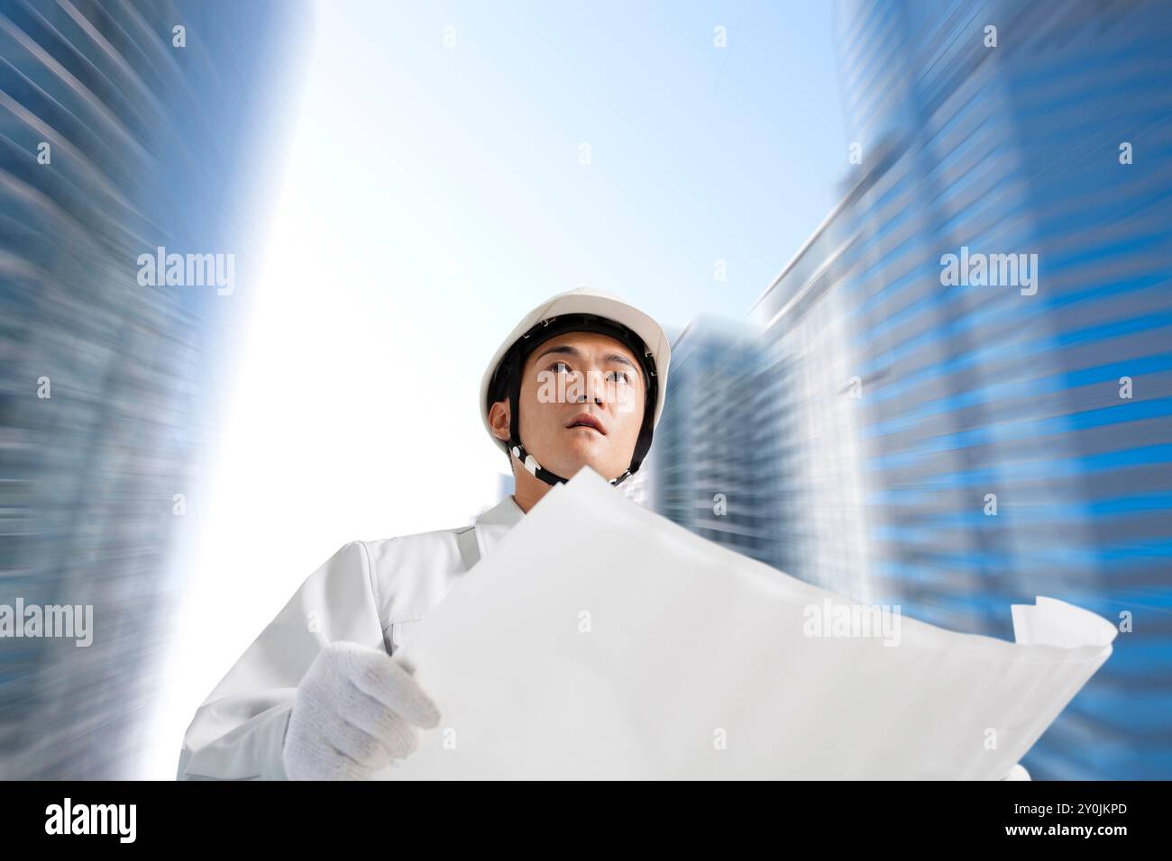 Male workers spreading out a diagram Stock Photo - Alamy