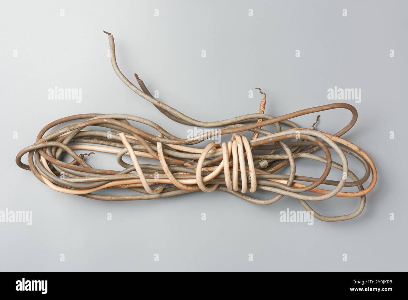 old use electric wires or cables isolated gray background, pile of ...