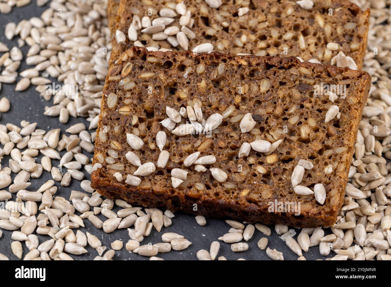 Black rye bread cut into chunks with sunflower seeds, a loaf of bread ...