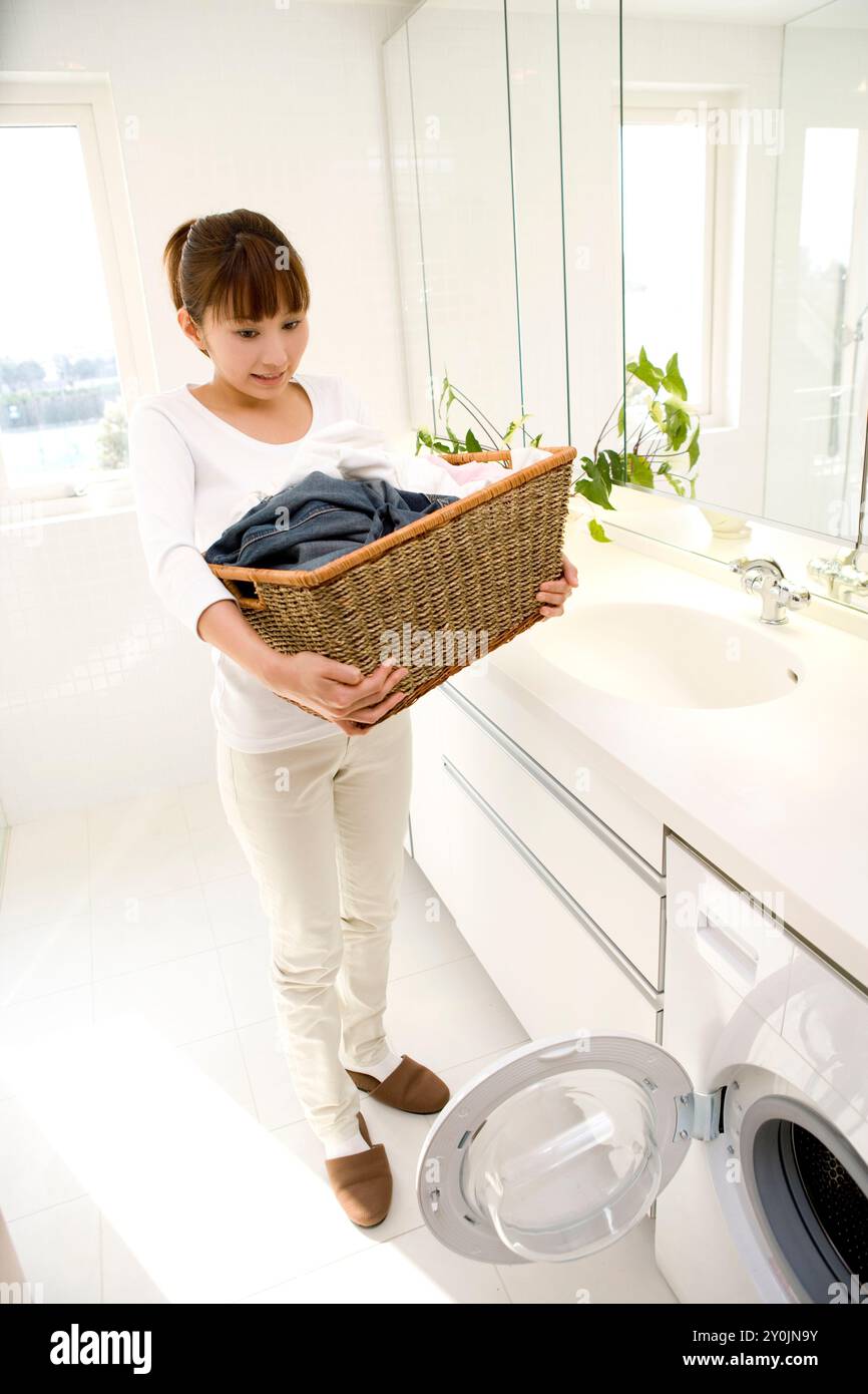 Woman doing laundry Stock Photo - Alamy
