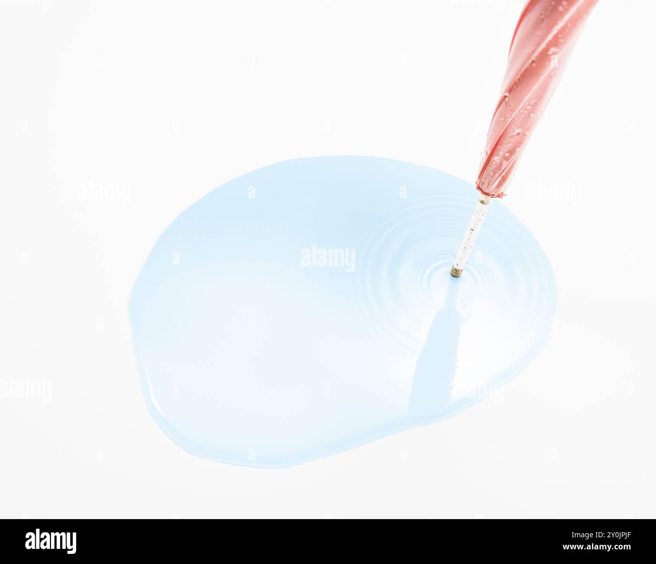 Light blue puddle and a pink umbrella Stock Photo - Alamy