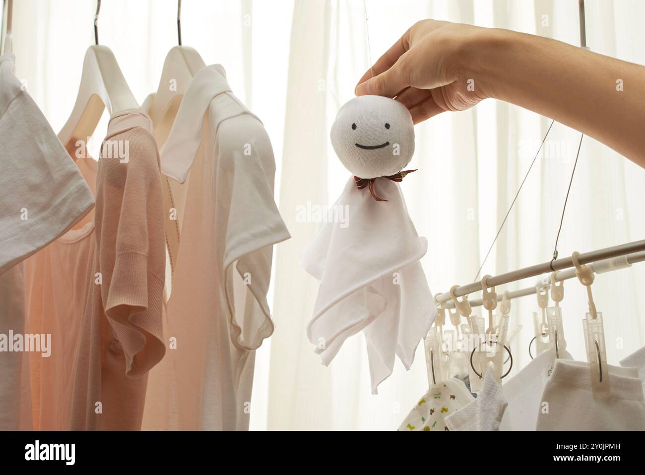 Indoor drying laundry and a paper doll Stock Photo - Alamy