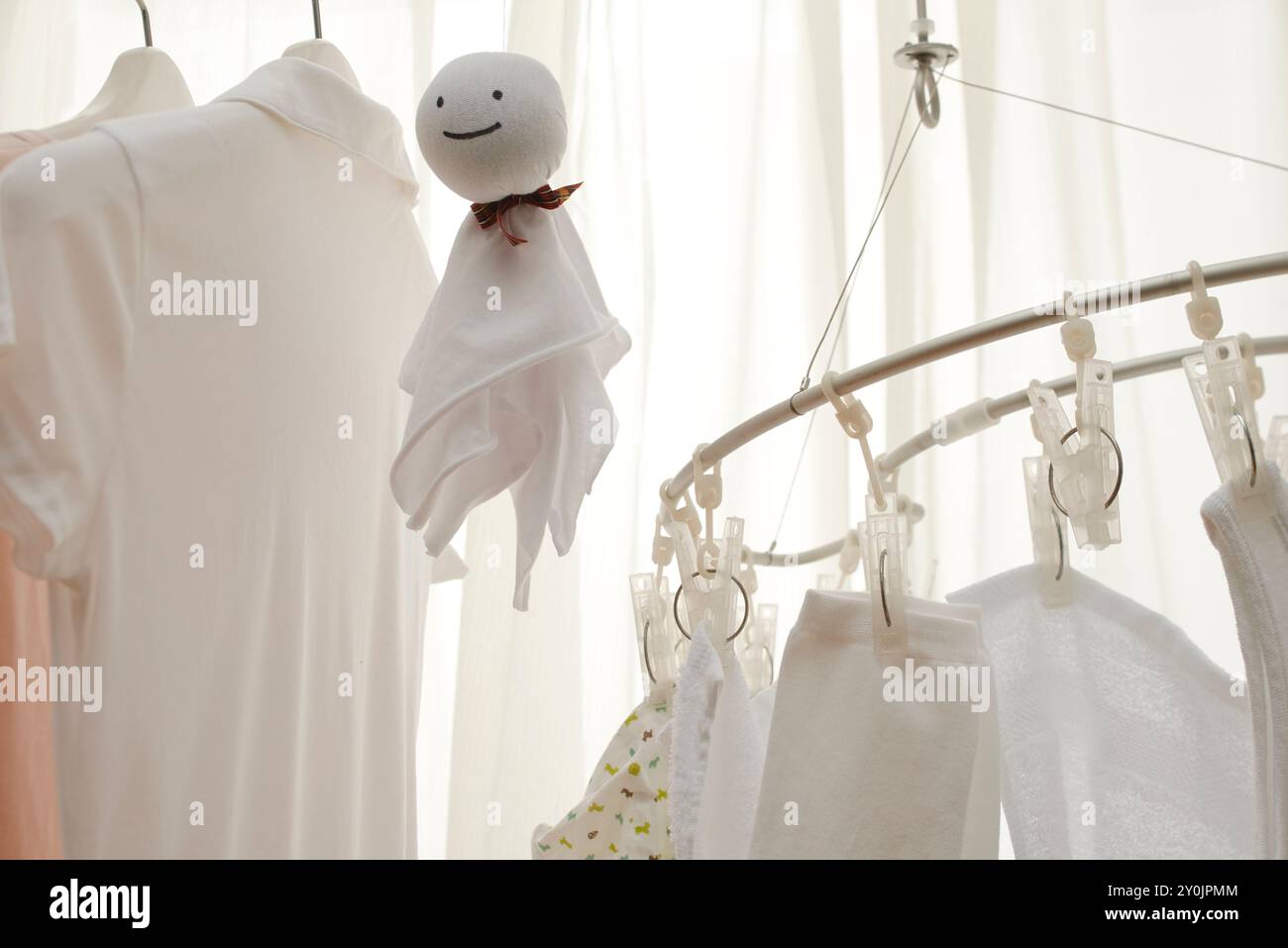 Indoor drying laundry and a paper doll Stock Photo - Alamy